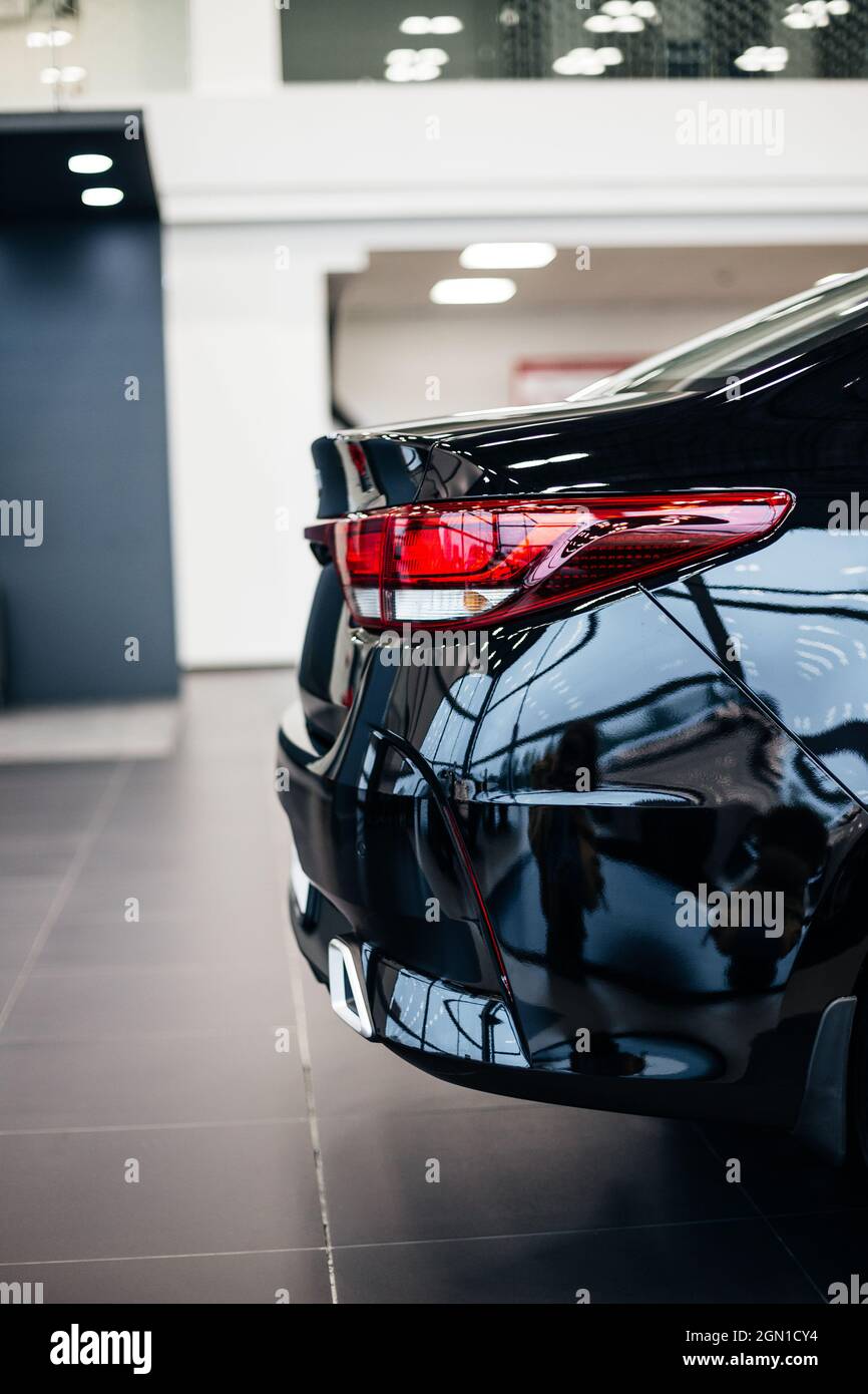 Close up back light of the modern black car. Rear car stop lights on ...