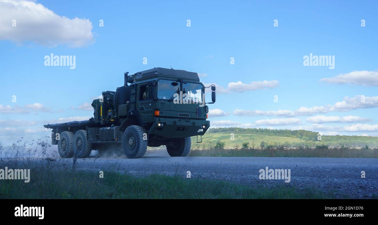 British army MAN HX58 Heavy Utility Truck driving along a stone dirt ...