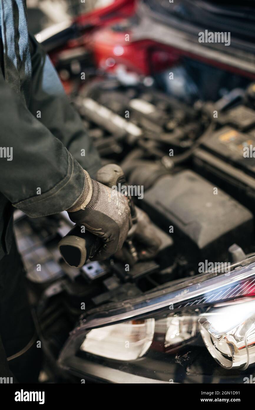 Mechanic examining and maintenance the engine car Stock Photo - Alamy