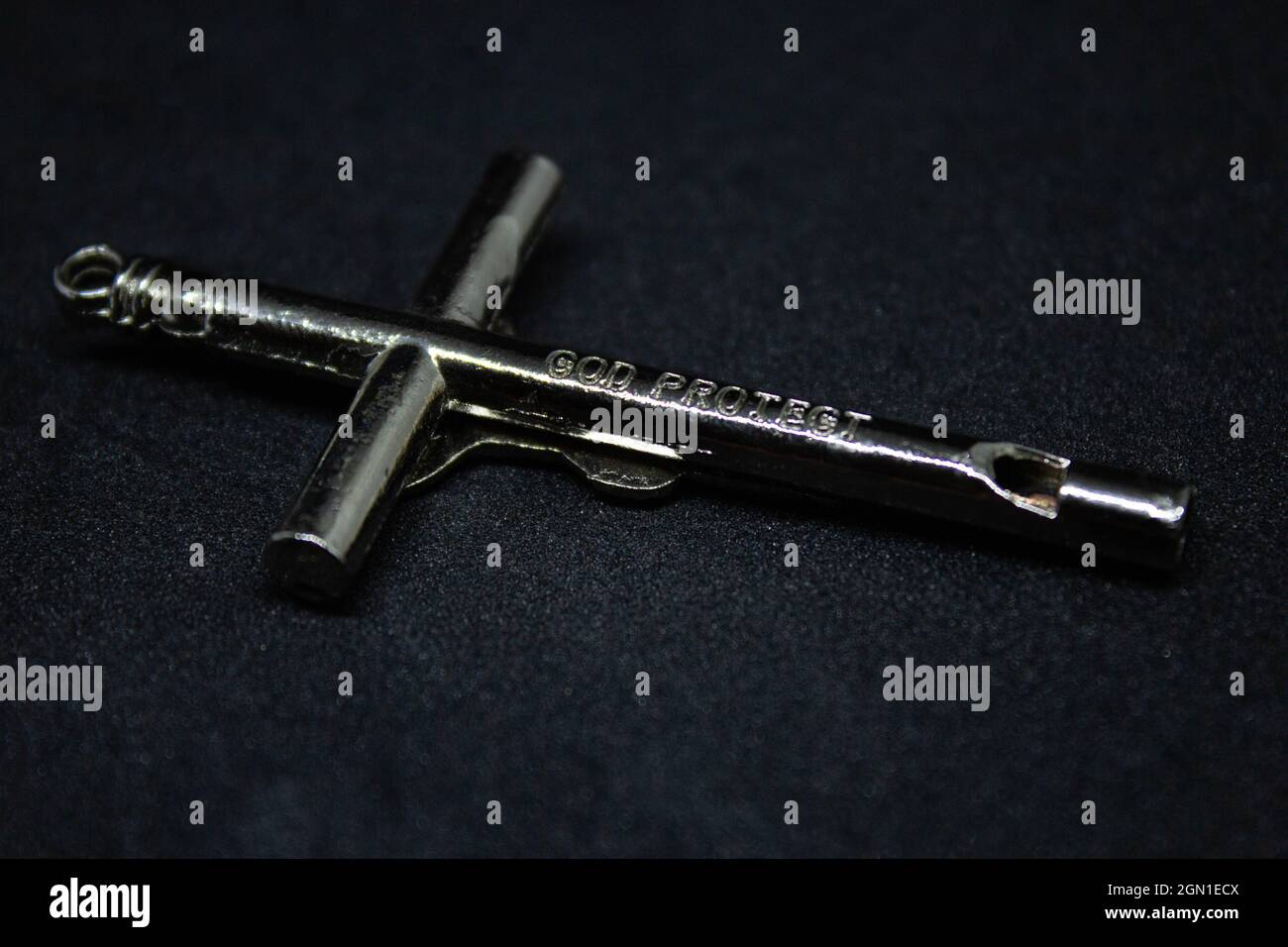 Silver cross. God protect written on it. Jesus served his life to save ...