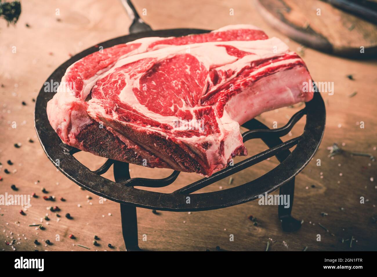Closeup of fresh raw meat on a metal stand Stock Photo - Alamy