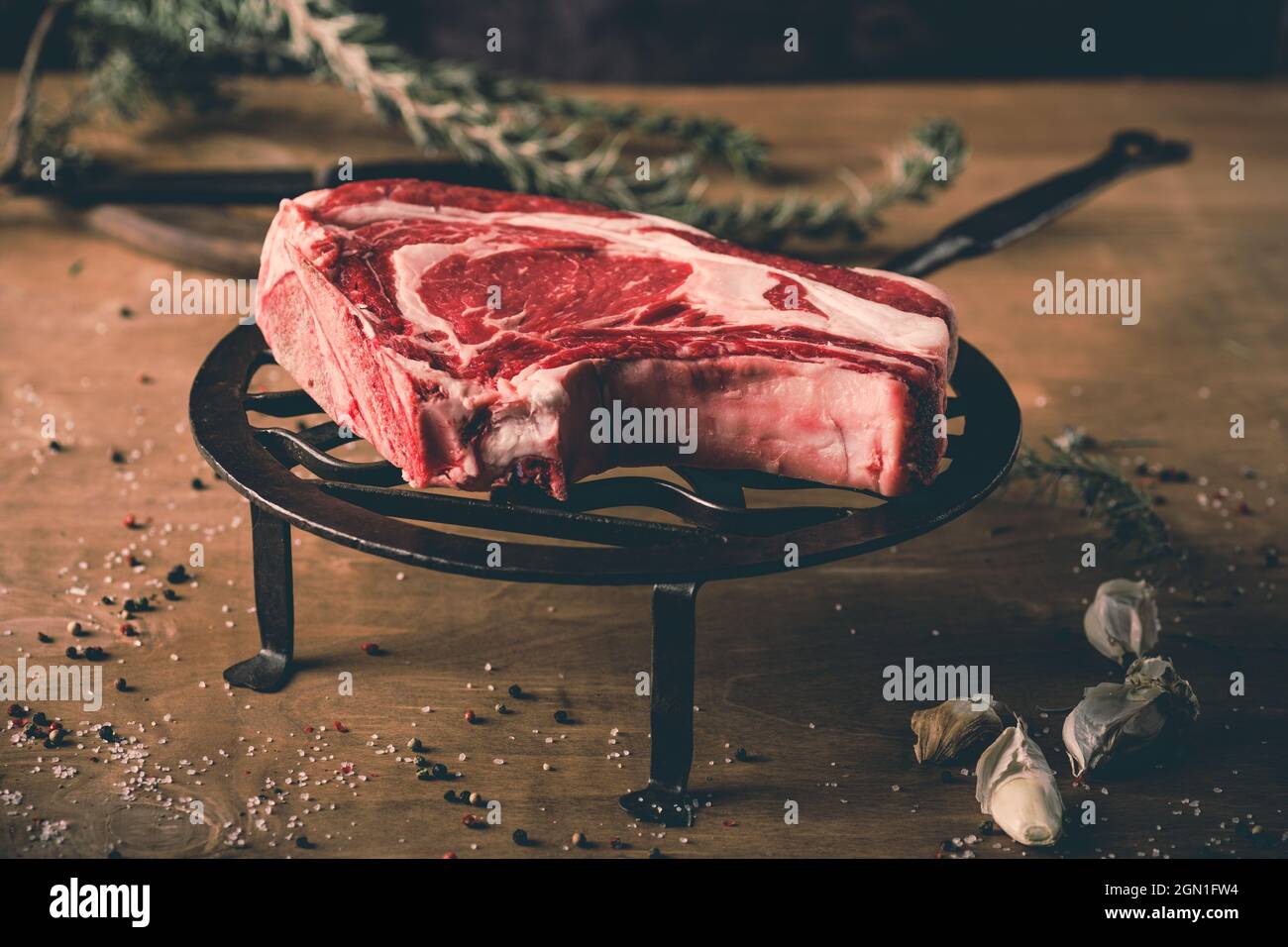 Closeup of fresh raw meat on a metal stand Stock Photo - Alamy