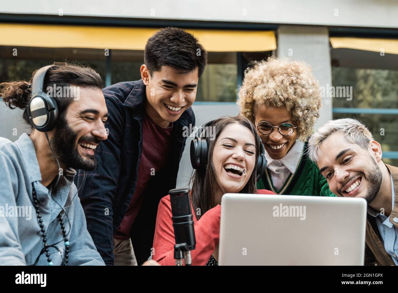 Happy people doing podcast online using microphone and laptop computer ...