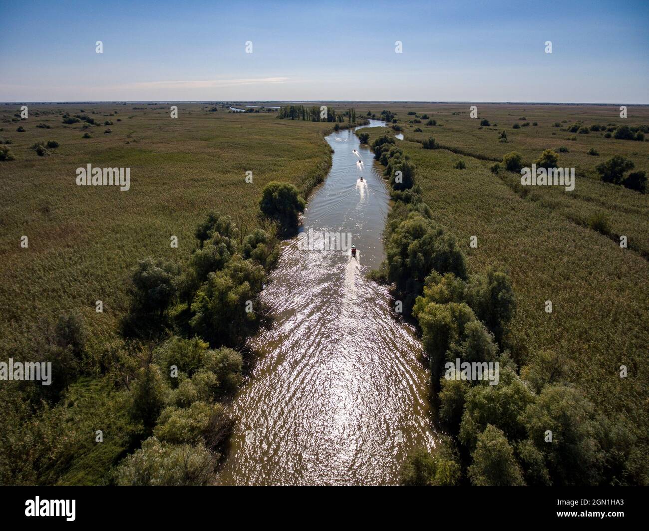 Aerial view of motorboat excursion to wetlands in the Volga Delta, near ...