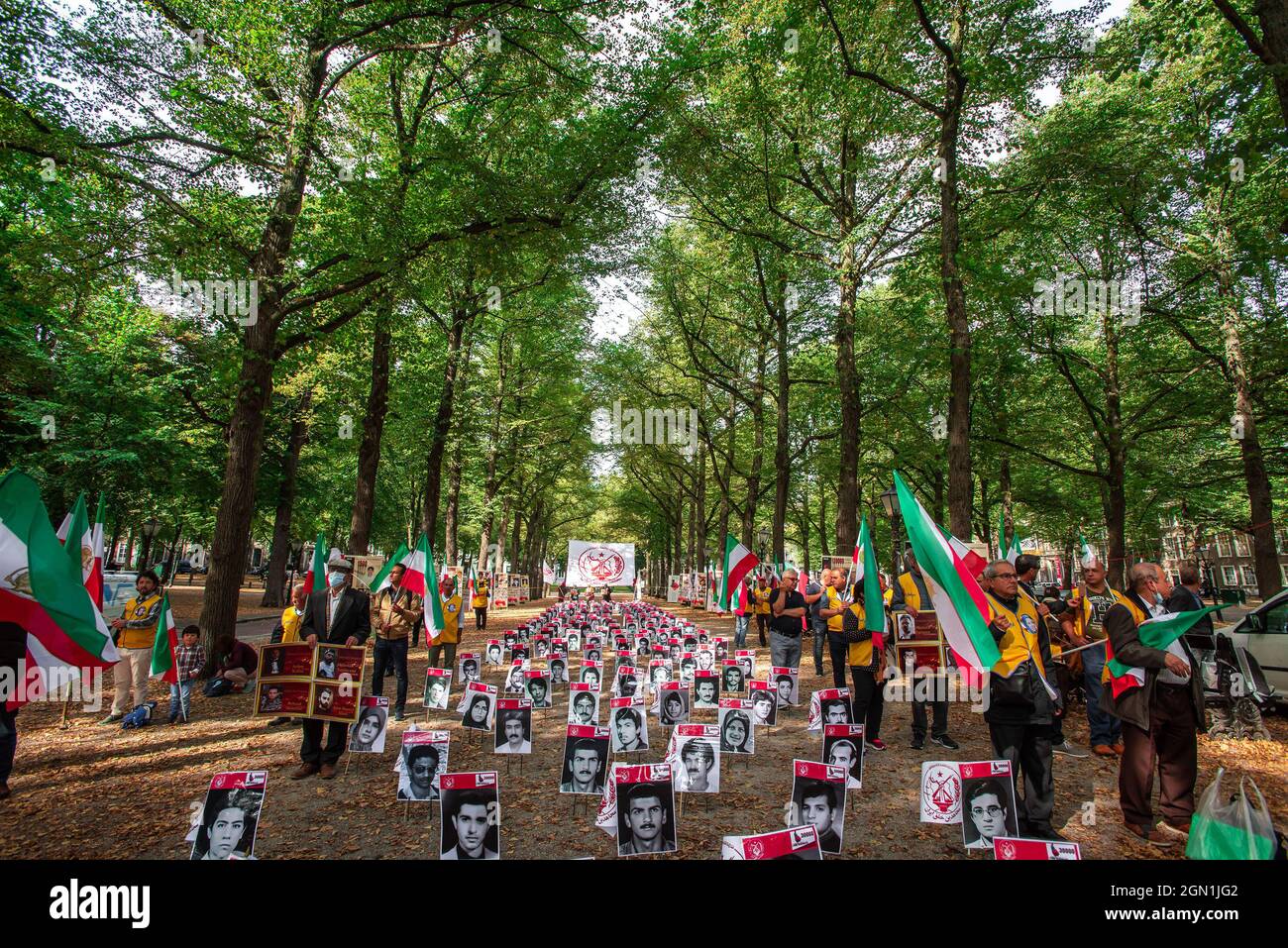 Iranian opposition activists holding flags and photos of pollical ...