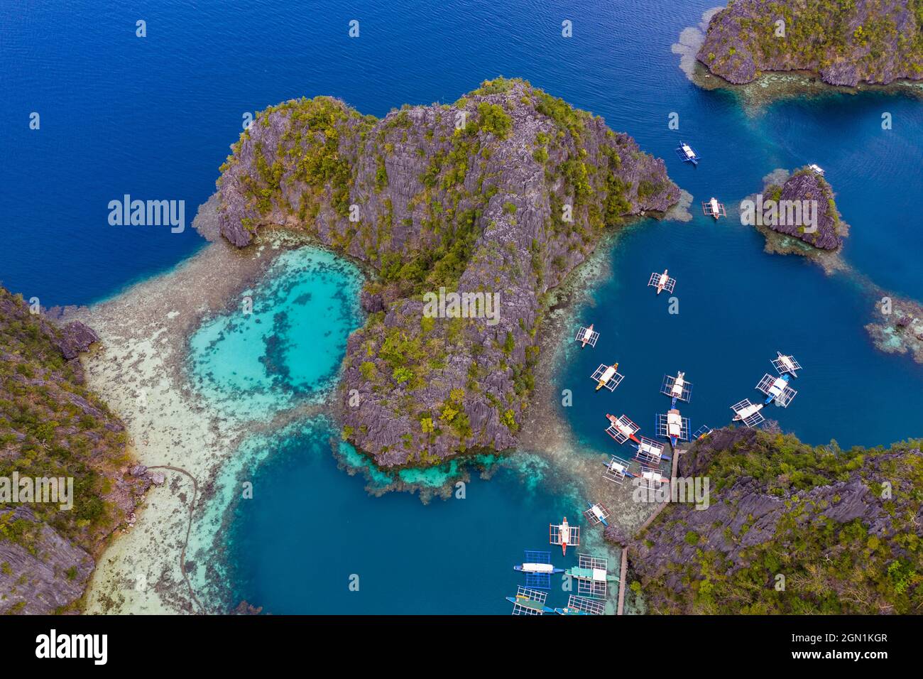 Aerial view of traditional Filipino Banca outrigger canoes lying in the ...