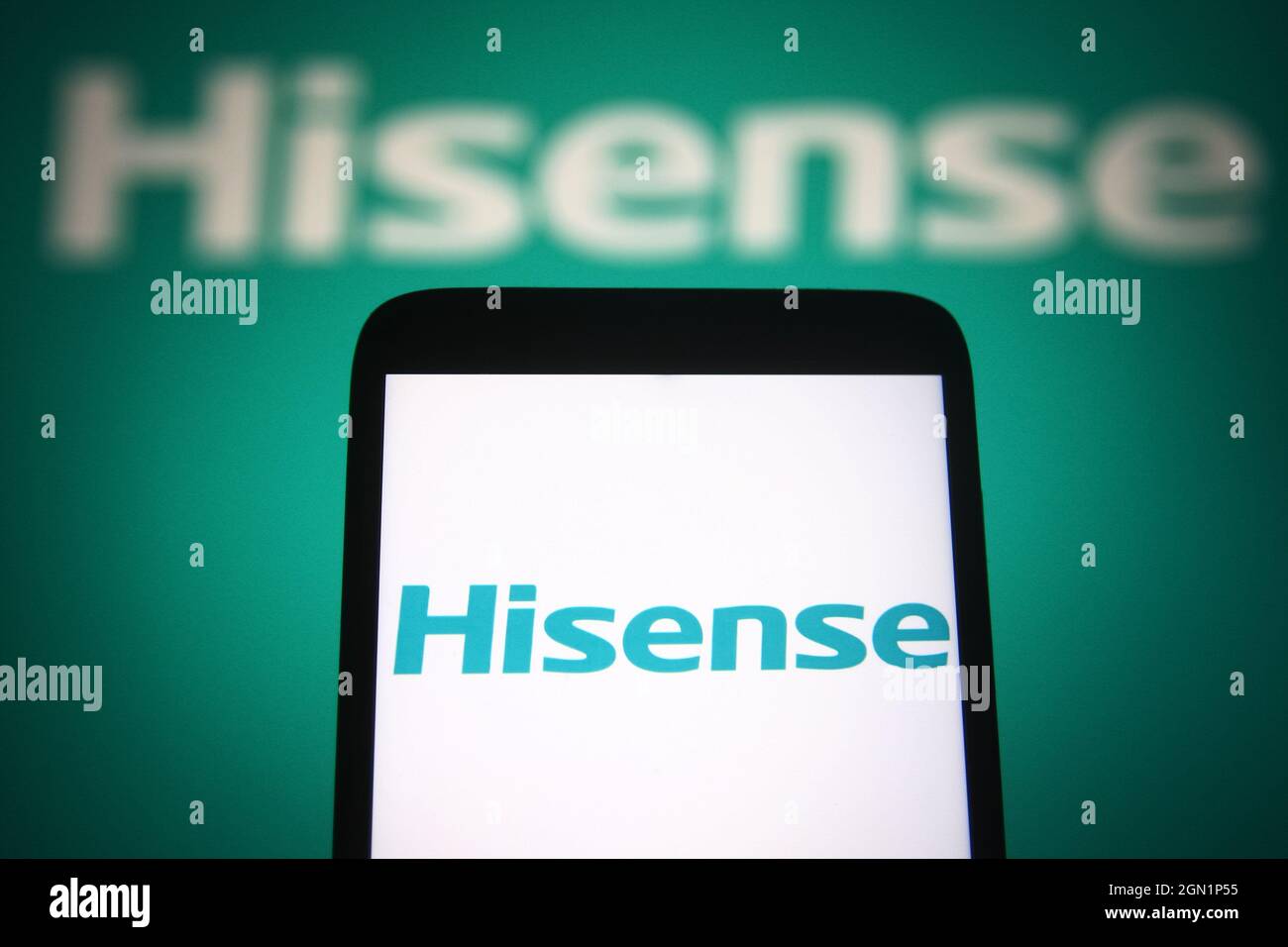 In this photo illustration a Hisense logo is seen on a smartphone and a ...