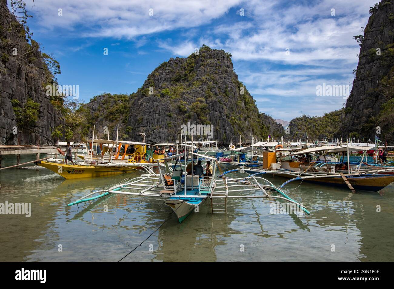 Traditional Filipino Banca outrigger canoes moored in the lagoon near ...