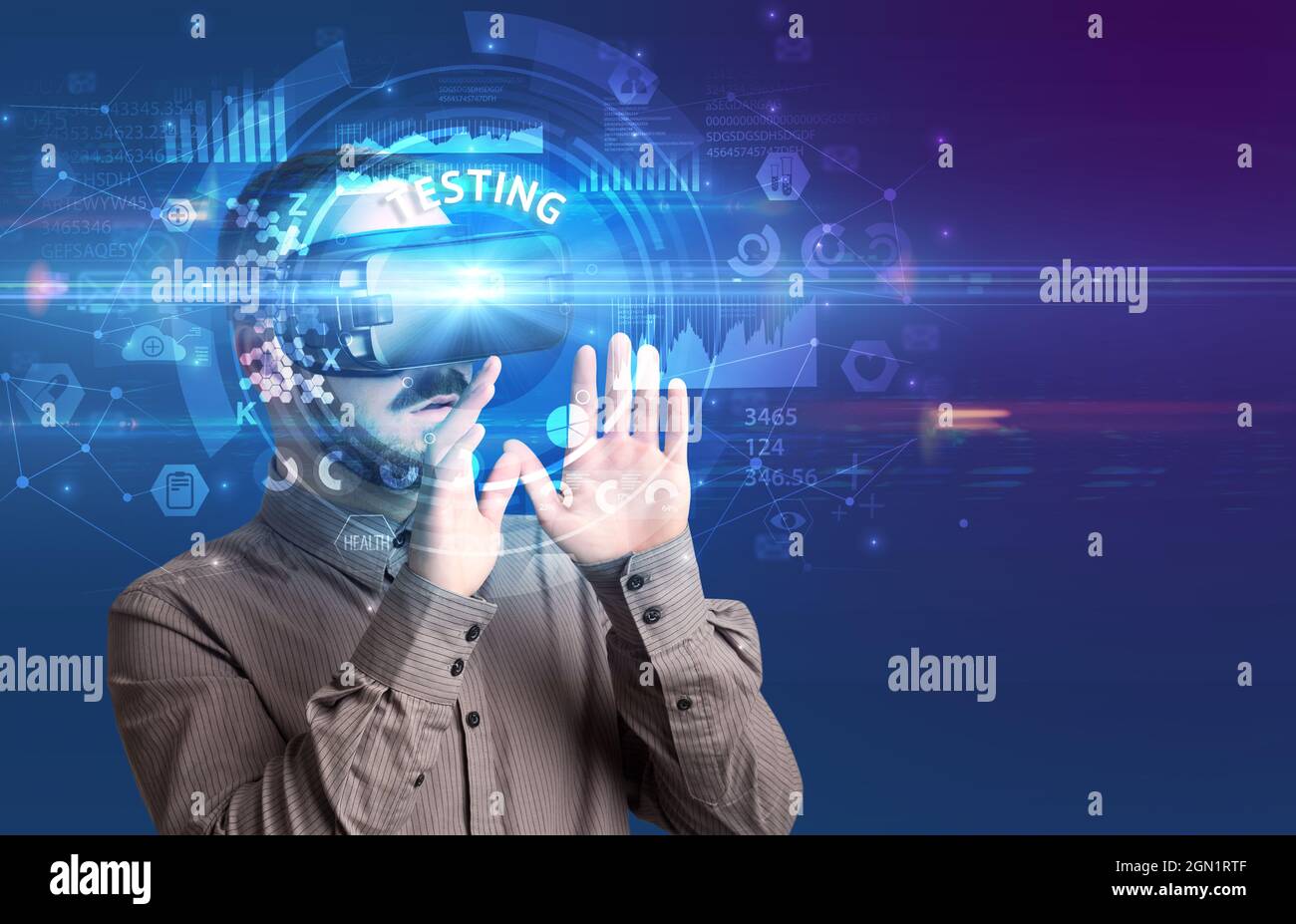Businessman looking through VR glasses Stock Photo - Alamy