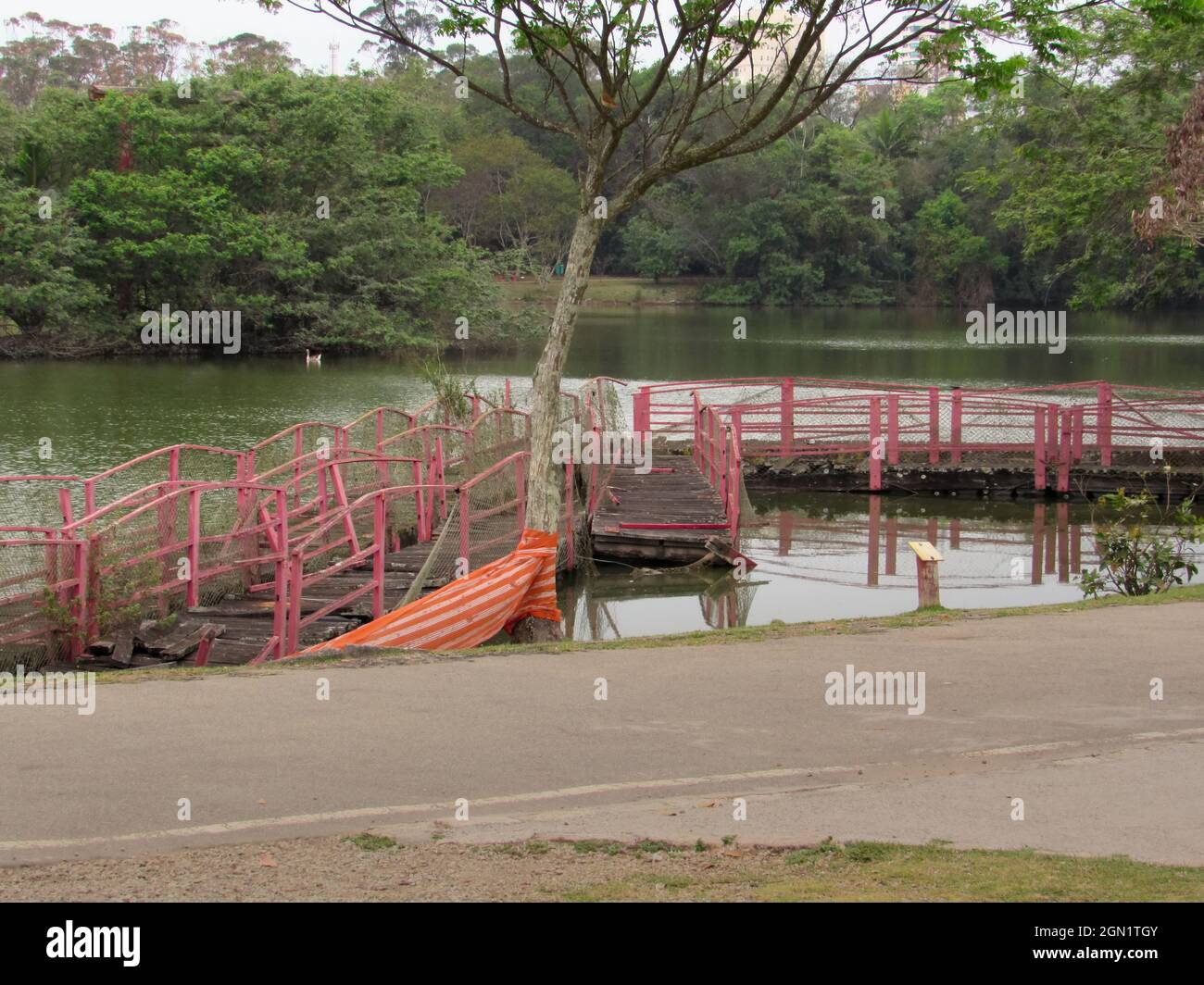 damaged floating bridge, leaning on the lake shore, with isolated ...