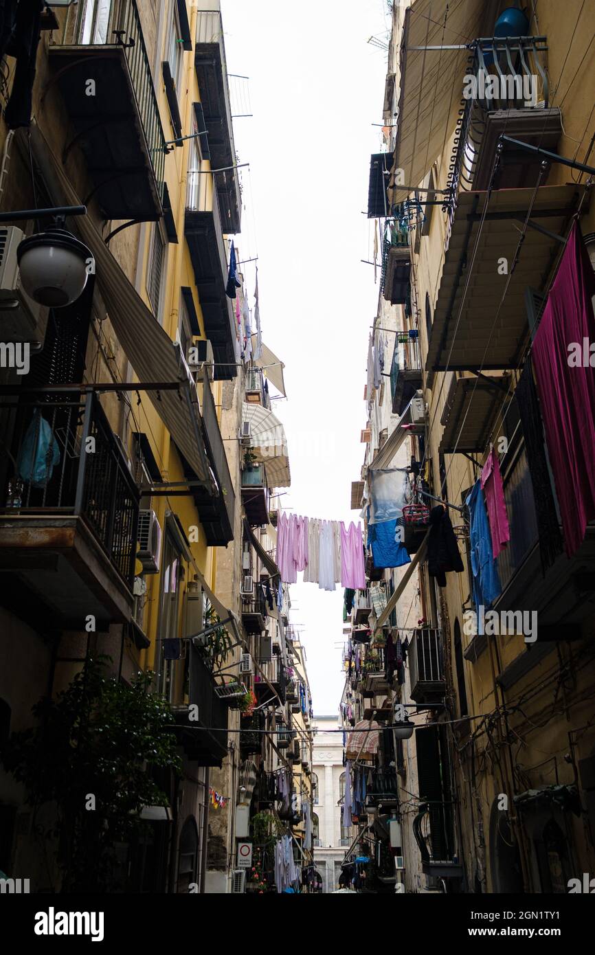 Vertical shot of a typical Italian alley with balconies and clothes ...