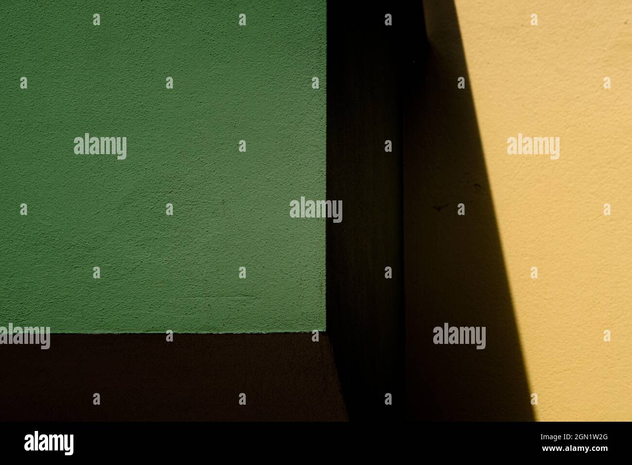 Closeup of the sharp angles of a building, yellow and green colored ...