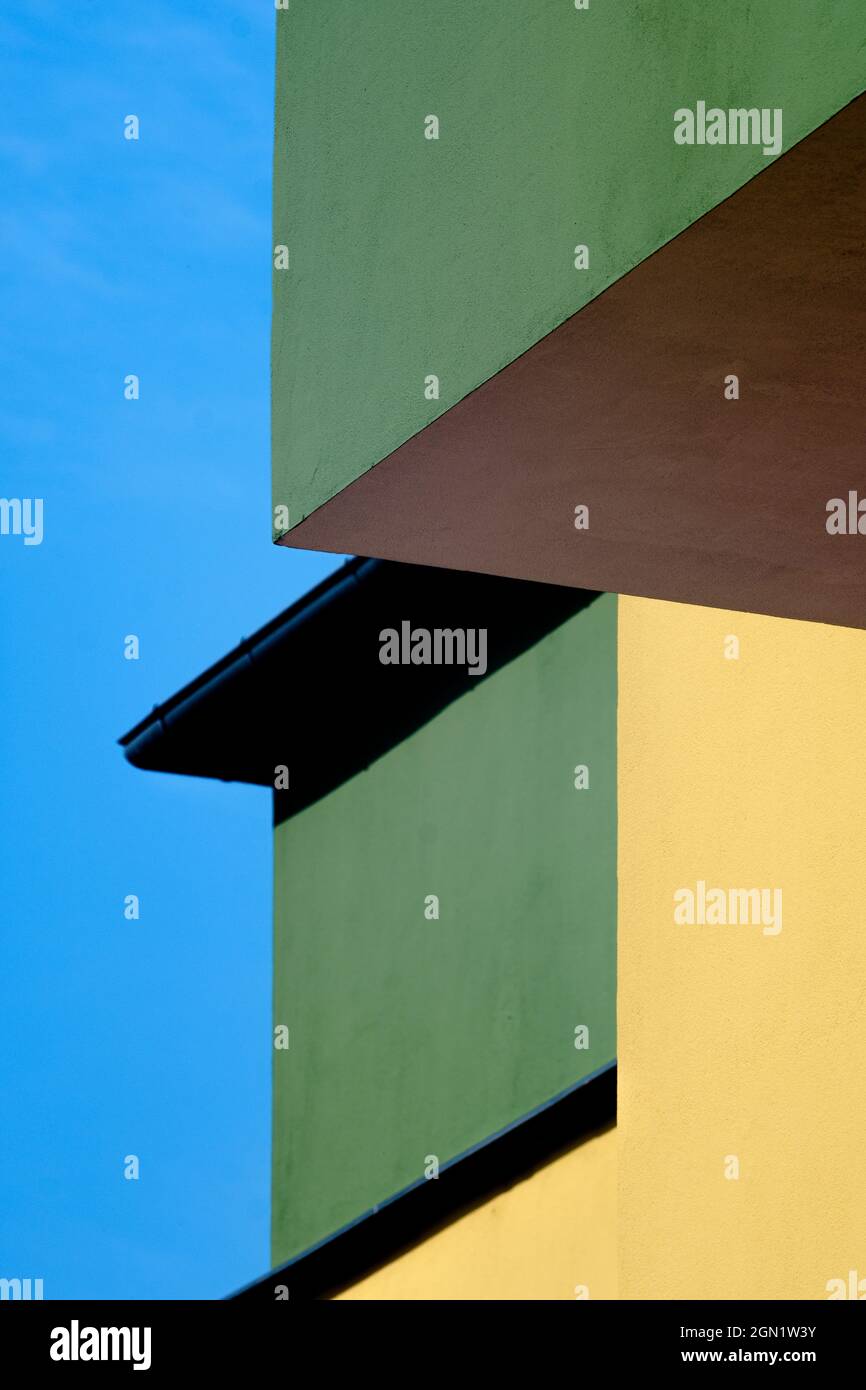 Vertical shot of the sharp angles of a building, yellow and green ...