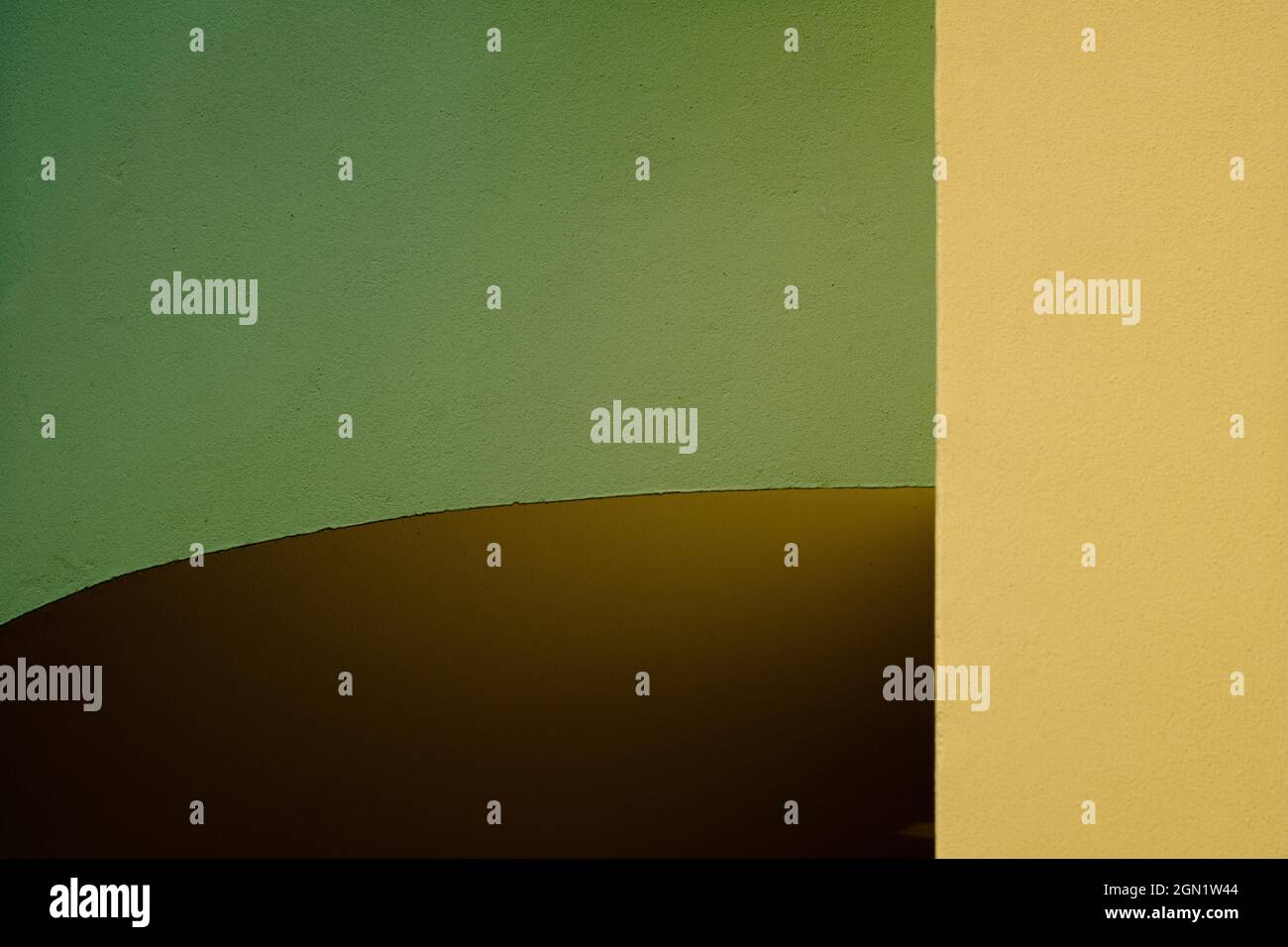 Closeup of the sharp angles of a building, yellow and green colored ...