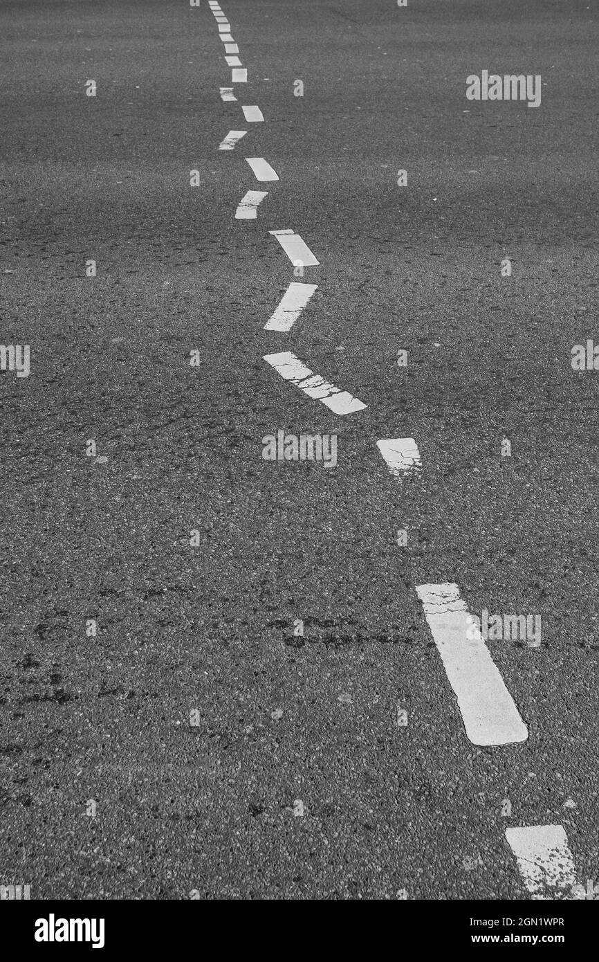 Vertical shot of wiggly traffic lines on an asphalt road Stock Photo ...
