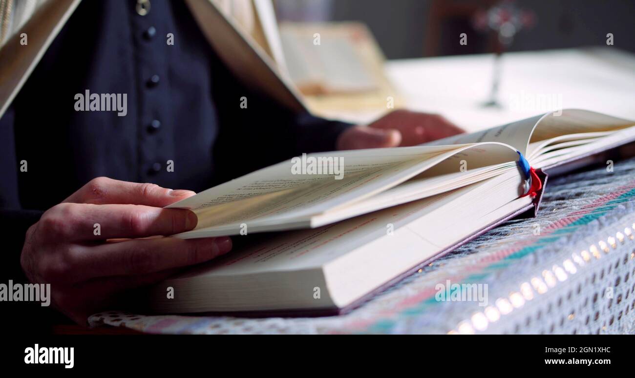 Church father reading bible hi-res stock photography and images - Alamy