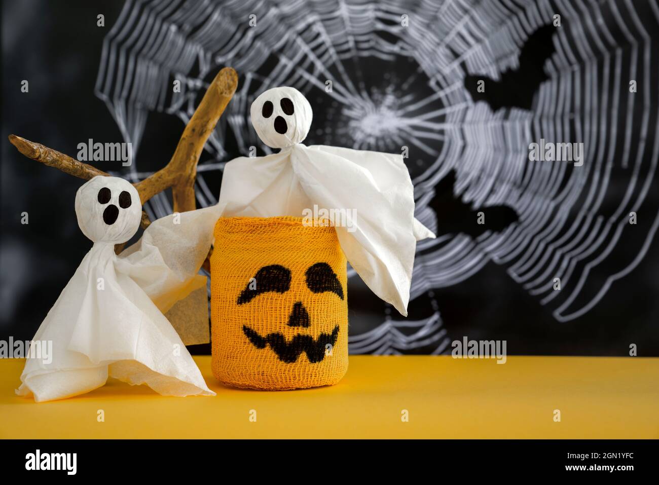 Two ghosts, candlestick with scary Halloween grimace on background of ...