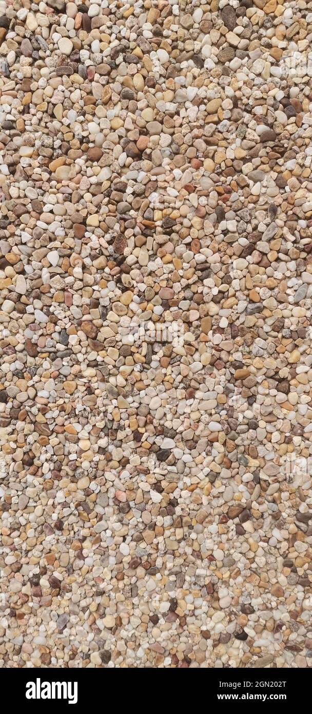 Vertical of a concrete wall with colorful small pebbles - good for ...