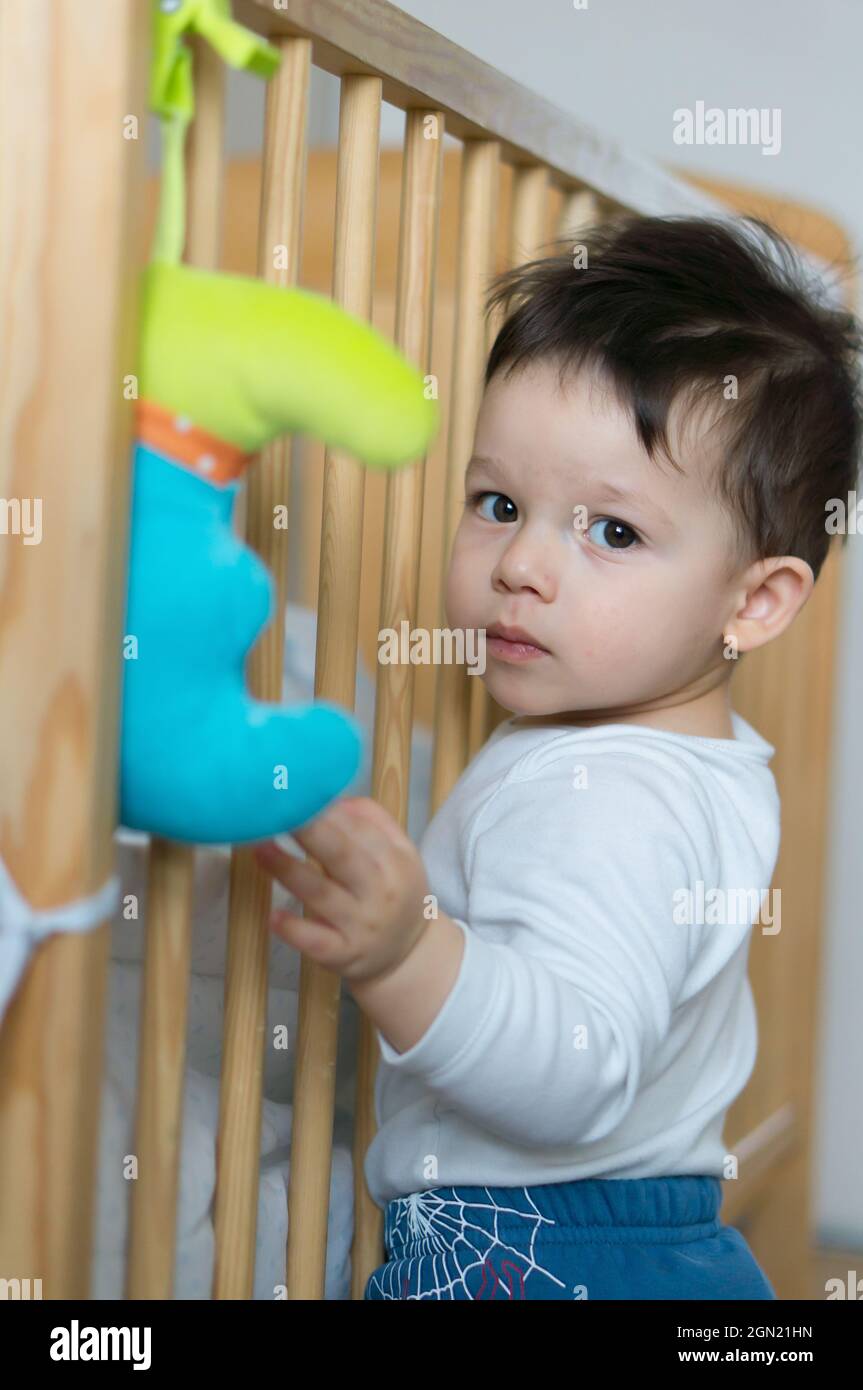 Cute Polish toddler boy standing near his bed Stock Photo - Alamy