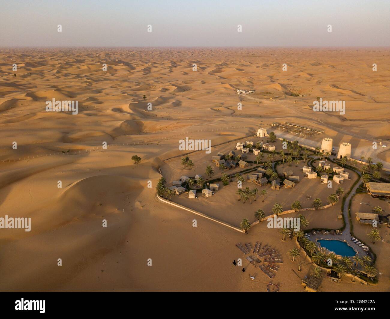 Aerial view of Arabian Nights Village desert resort amidst dunes ...
