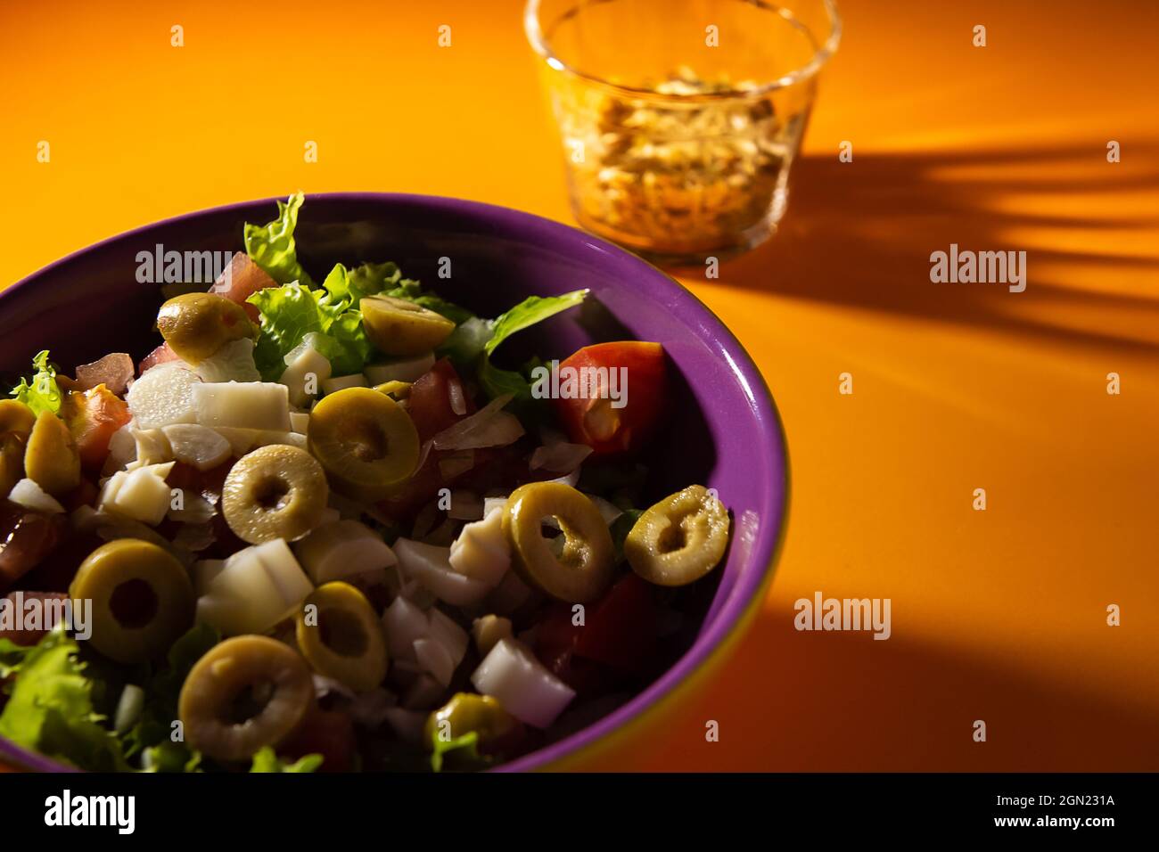 A bowl of salad and a small bowl of dehydrated spices Stock Photo - Alamy