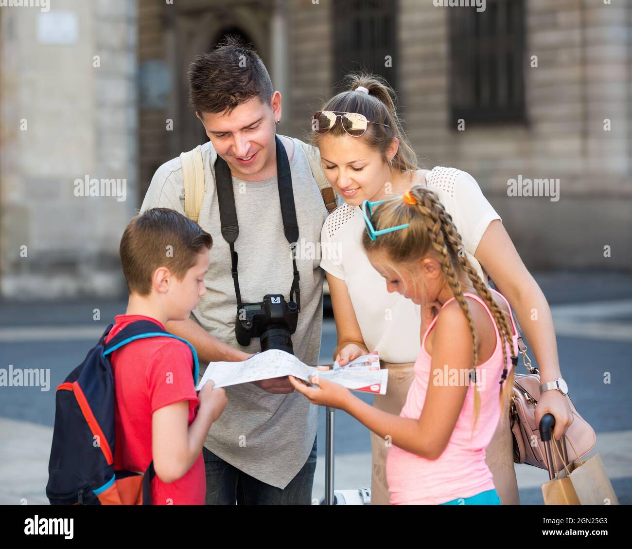 Happy family travelers with two kids with map outdoor Stock Photo - Alamy