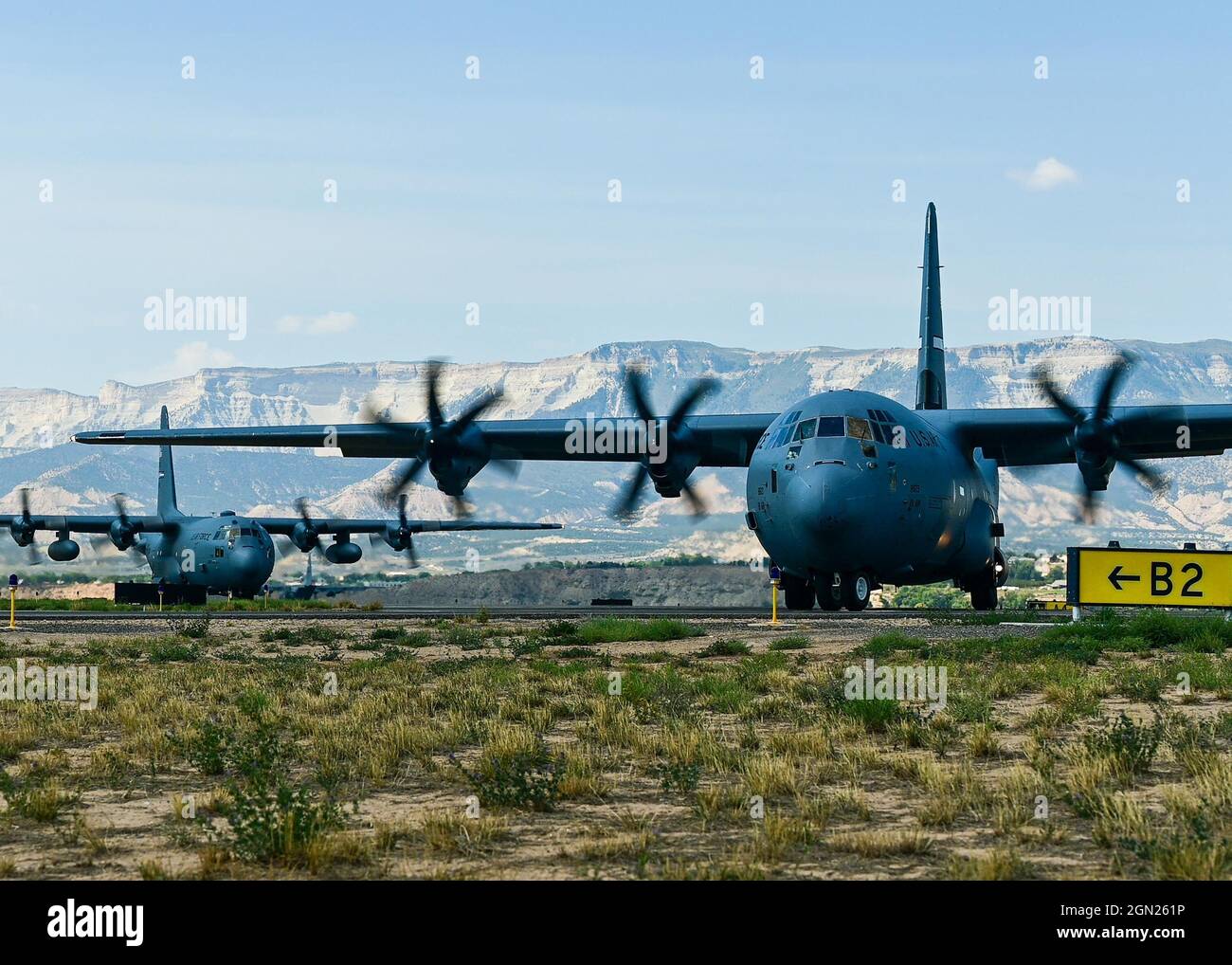 A C-130J Super Hercules and a C-130H Hercules taxi to the parking ramp ...