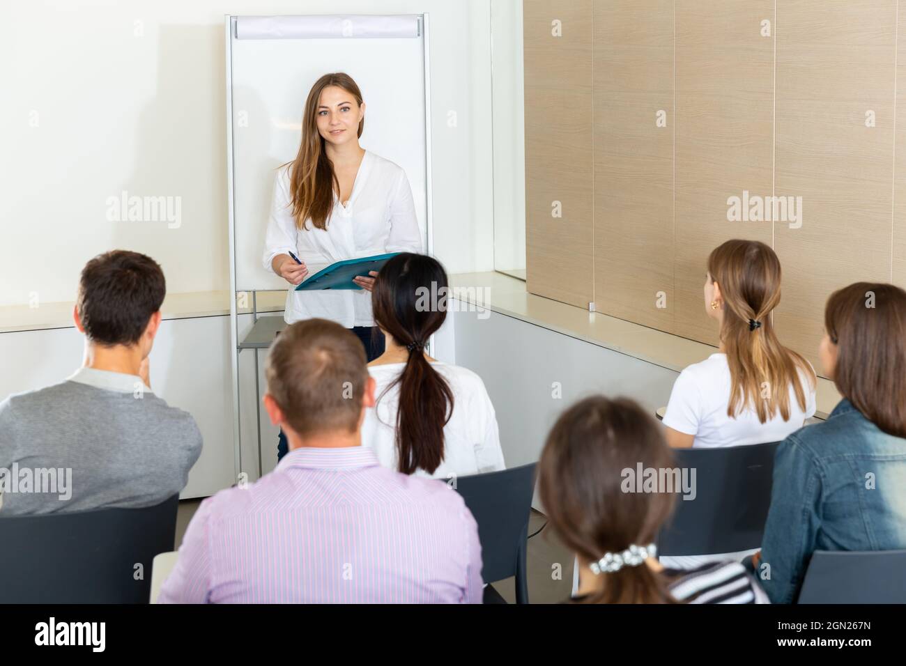 Woman sharing business ideas with colleagues Stock Photo - Alamy