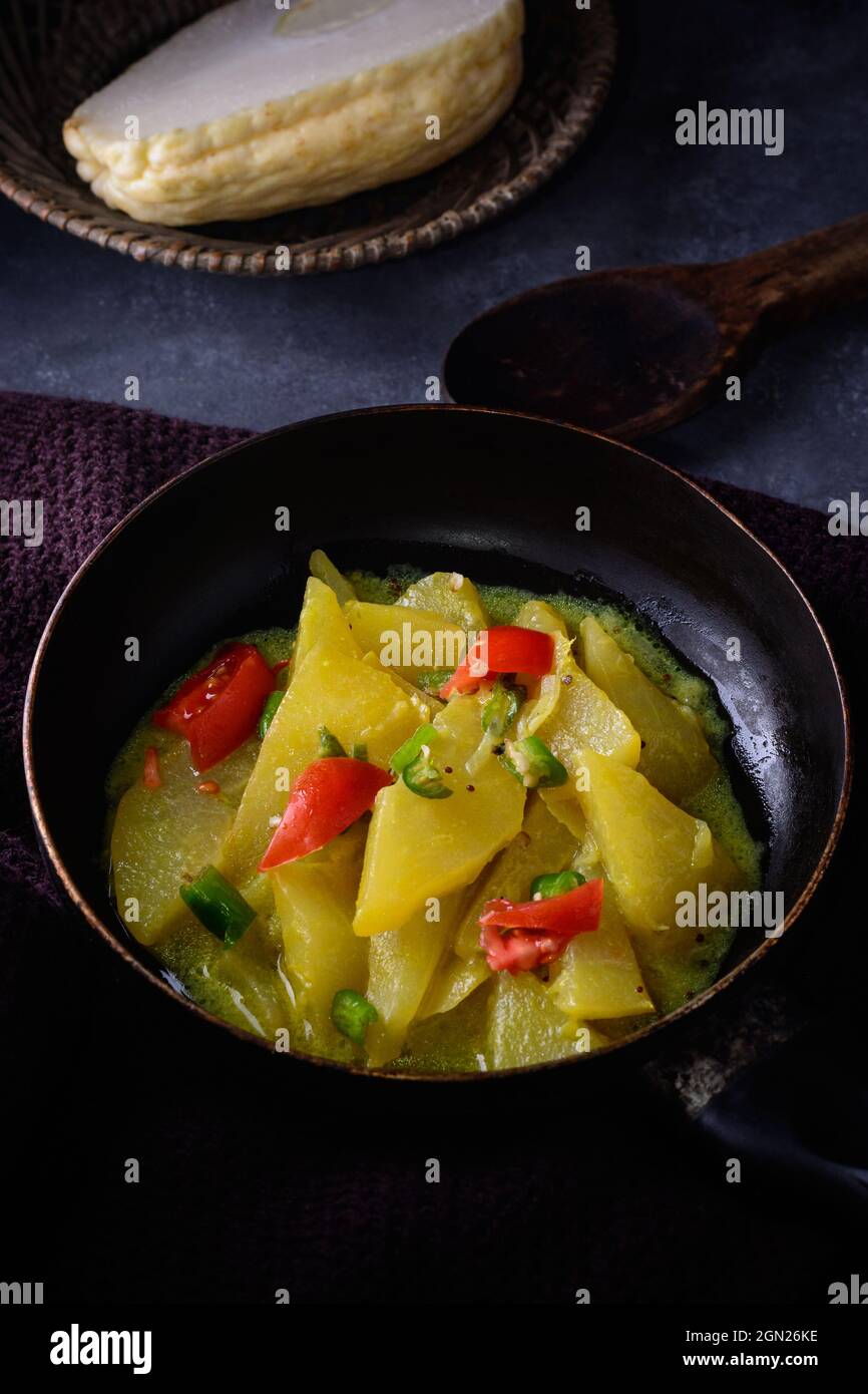 cooked chayote or chow chow dish with tomatoes and green chillies on a ...