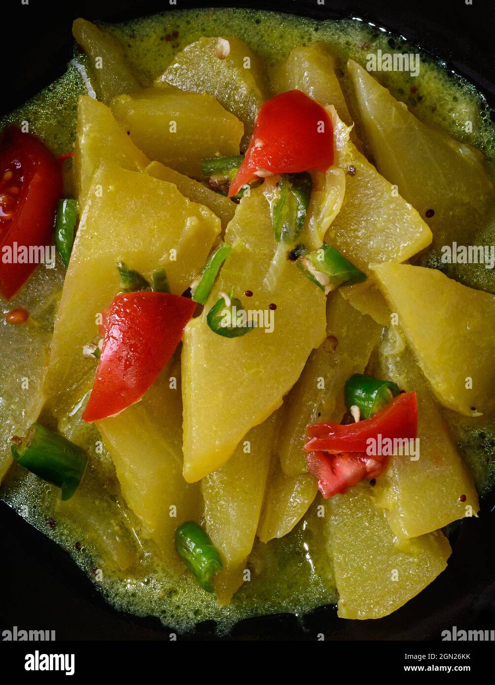 cooked chayote or chow chow dish with tomatoes and green chillies on a ...