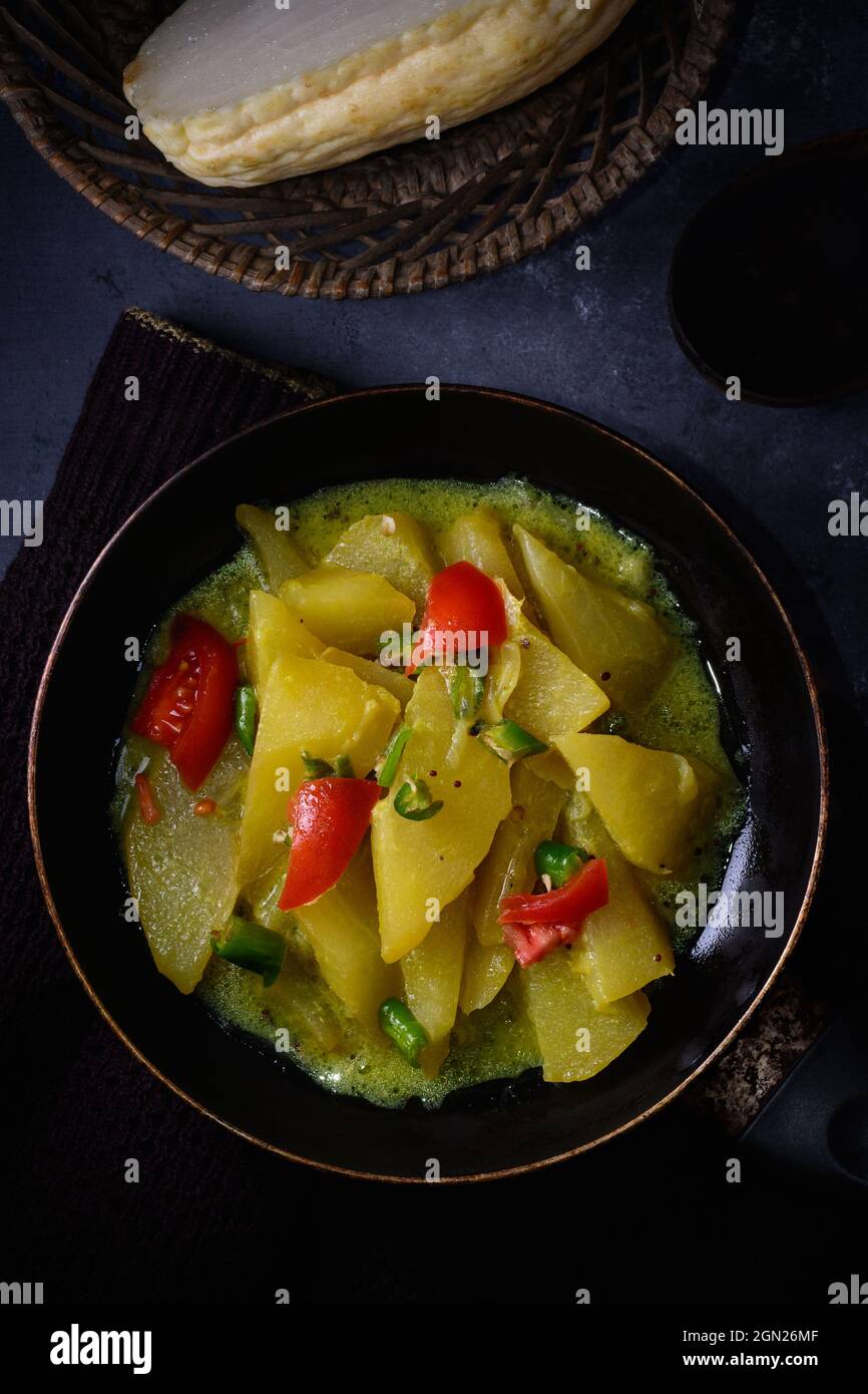 cooked chayote or chow chow dish with tomatoes and green chillies on a ...