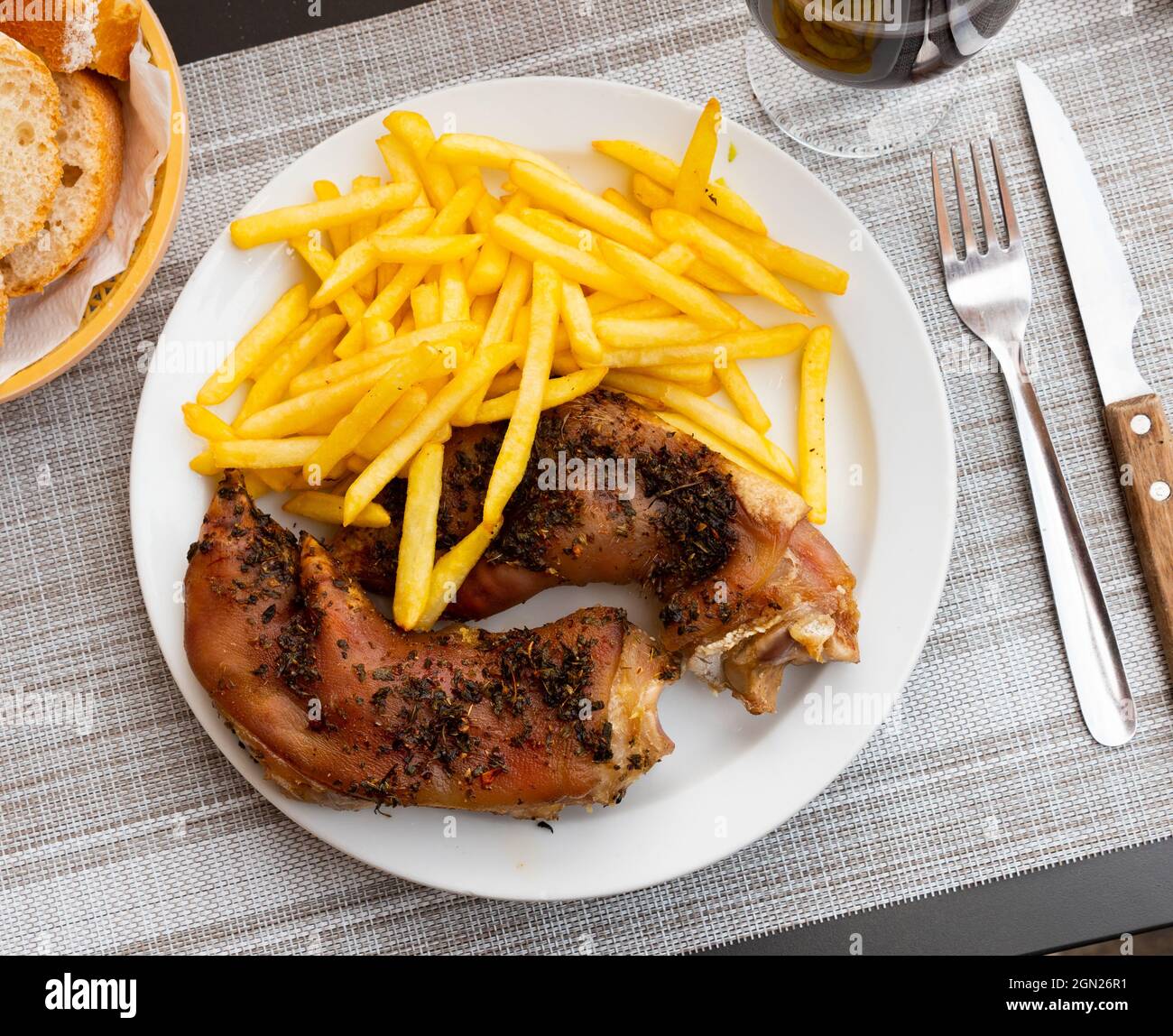 Spicy baked pig trotters with french fries Stock Photo - Alamy
