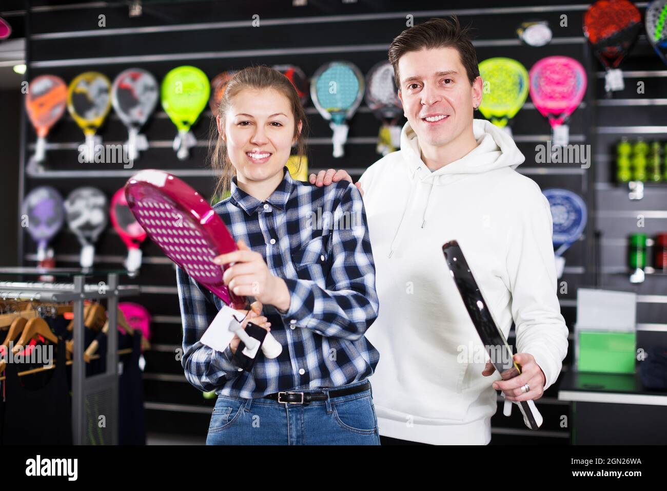 Couple with padel racket in store Stock Photo - Alamy
