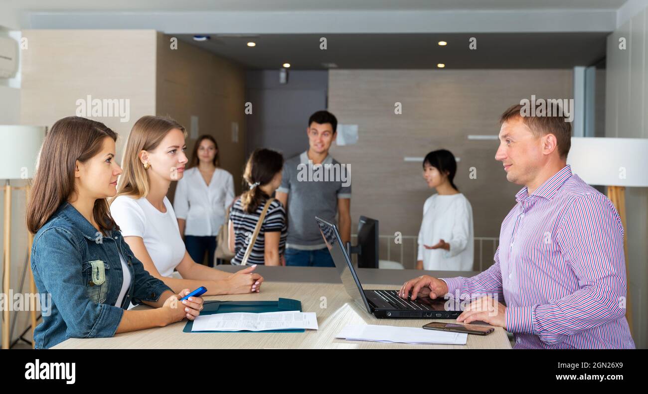 Friendly lawyer consulting his female clients Stock Photo - Alamy
