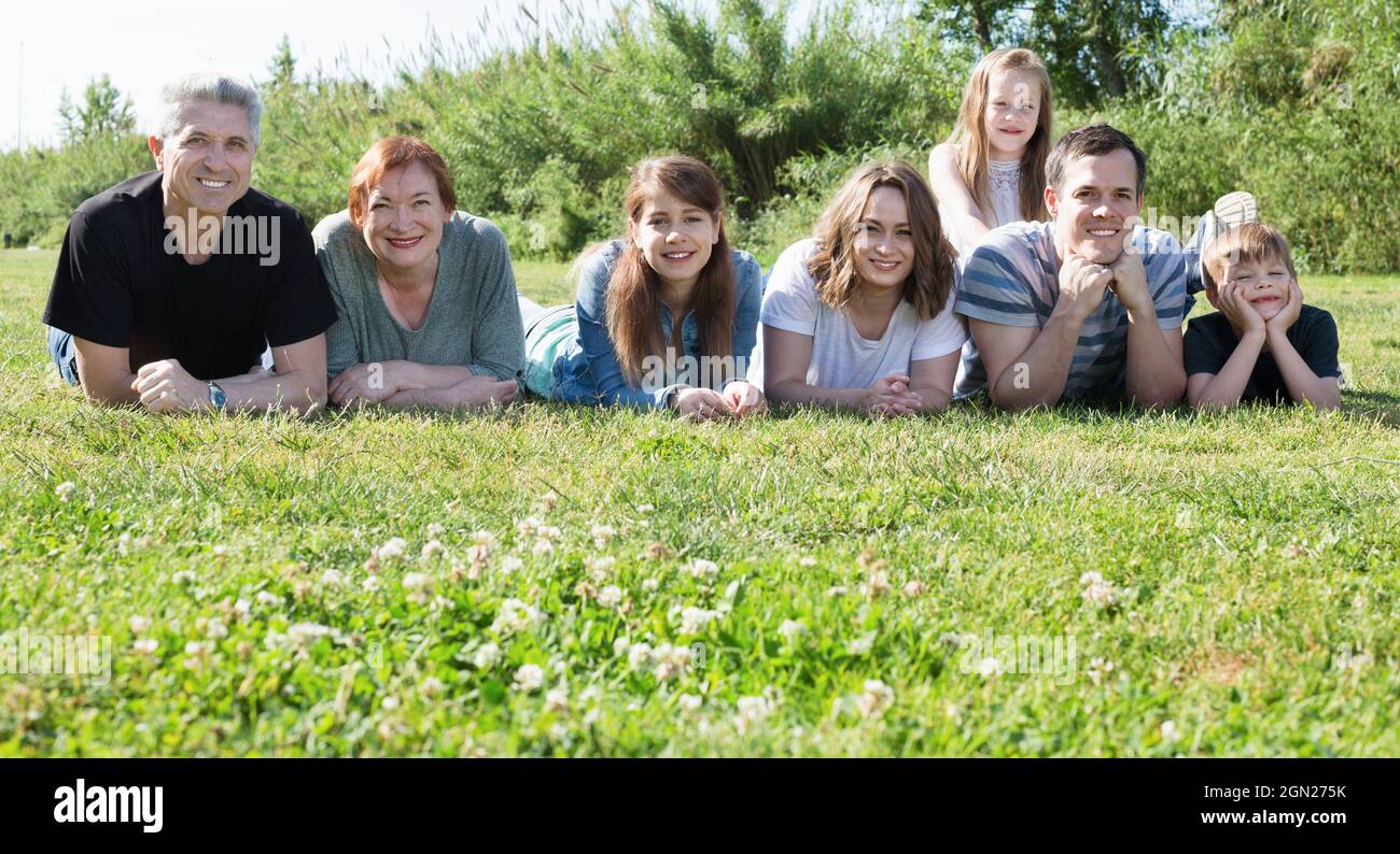People of different ages taking photos on the lawn Stock Photo - Alamy