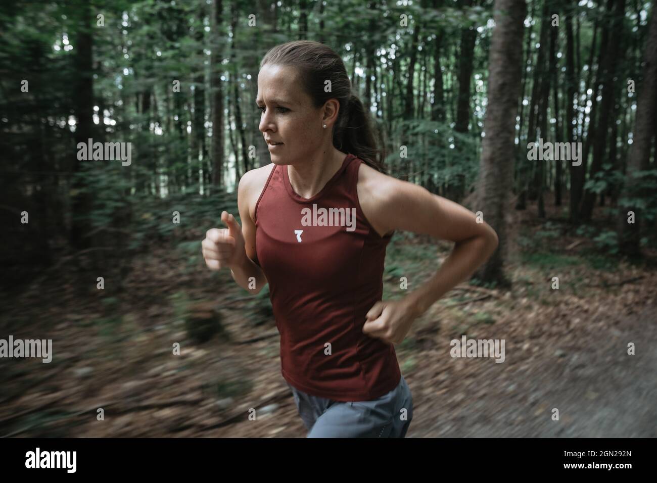 Female runner running through forest hi-res stock photography and ...