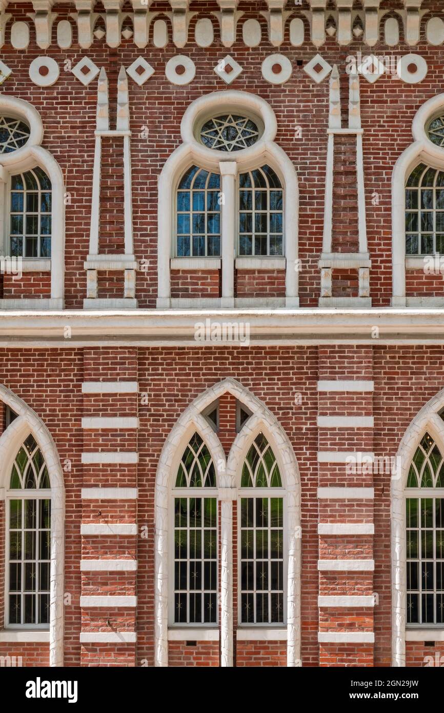 Brick wall of an old 18th century building with large windows. Large ...