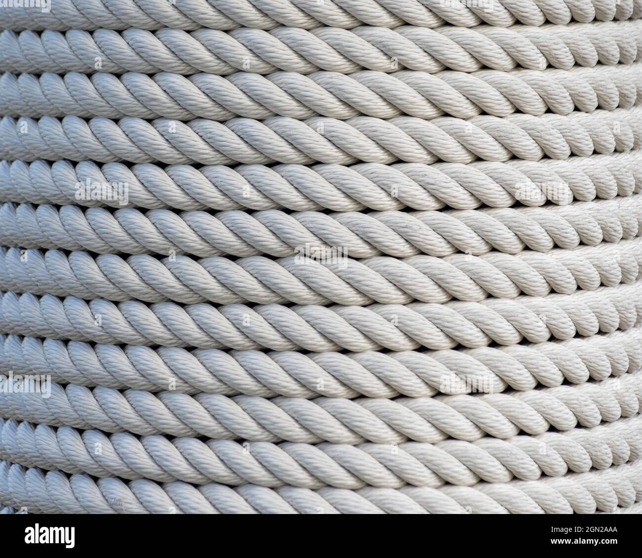 Rows of rope wrapped tightly around a wooden post Stock Photo - Alamy