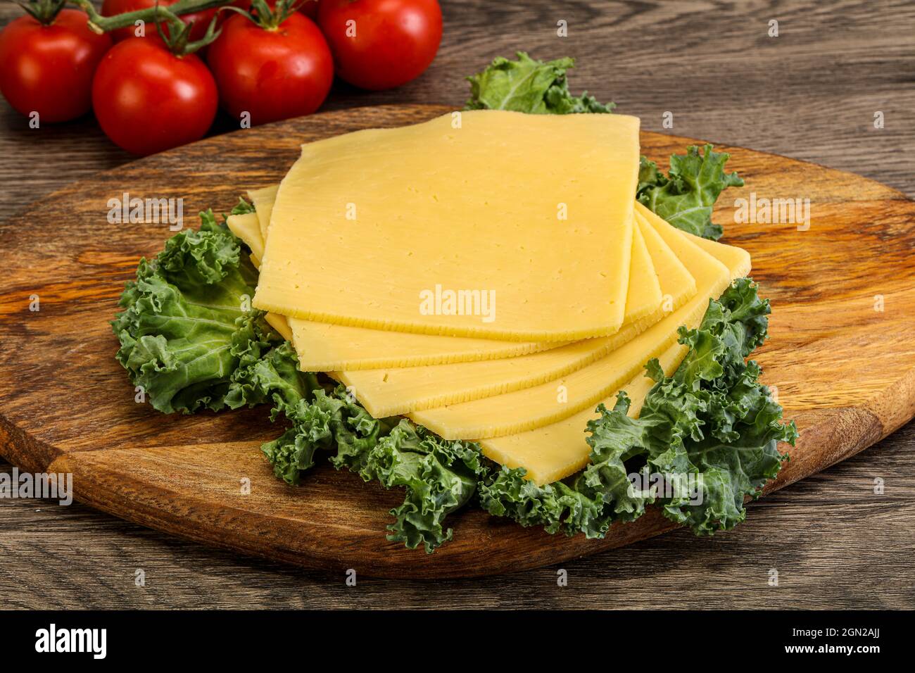 Sliced Gauda cheese snack over board Stock Photo - Alamy