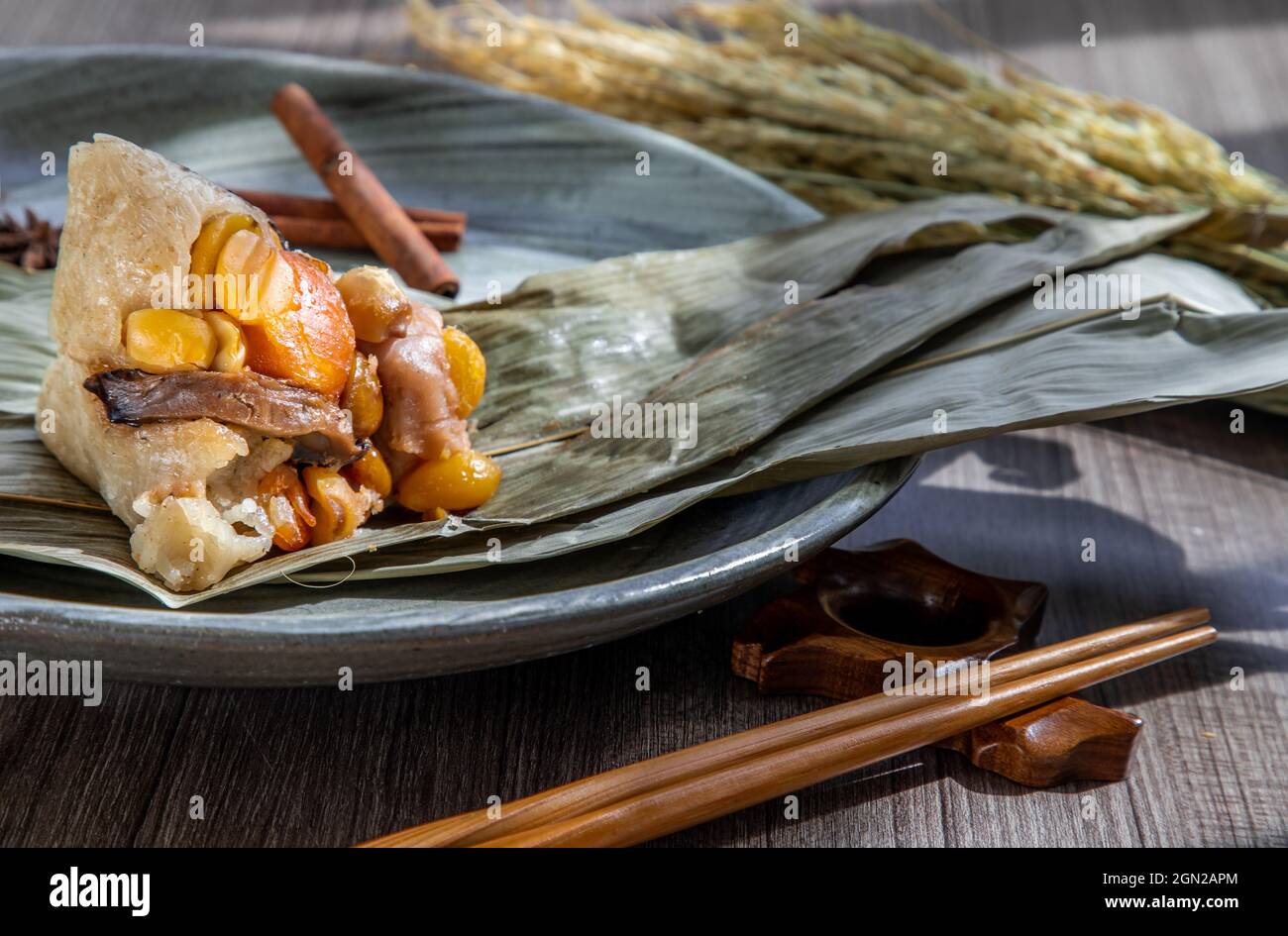 Chinese rice dumpling (Zongzi) shaped pyramidal wrapped by leaves ...