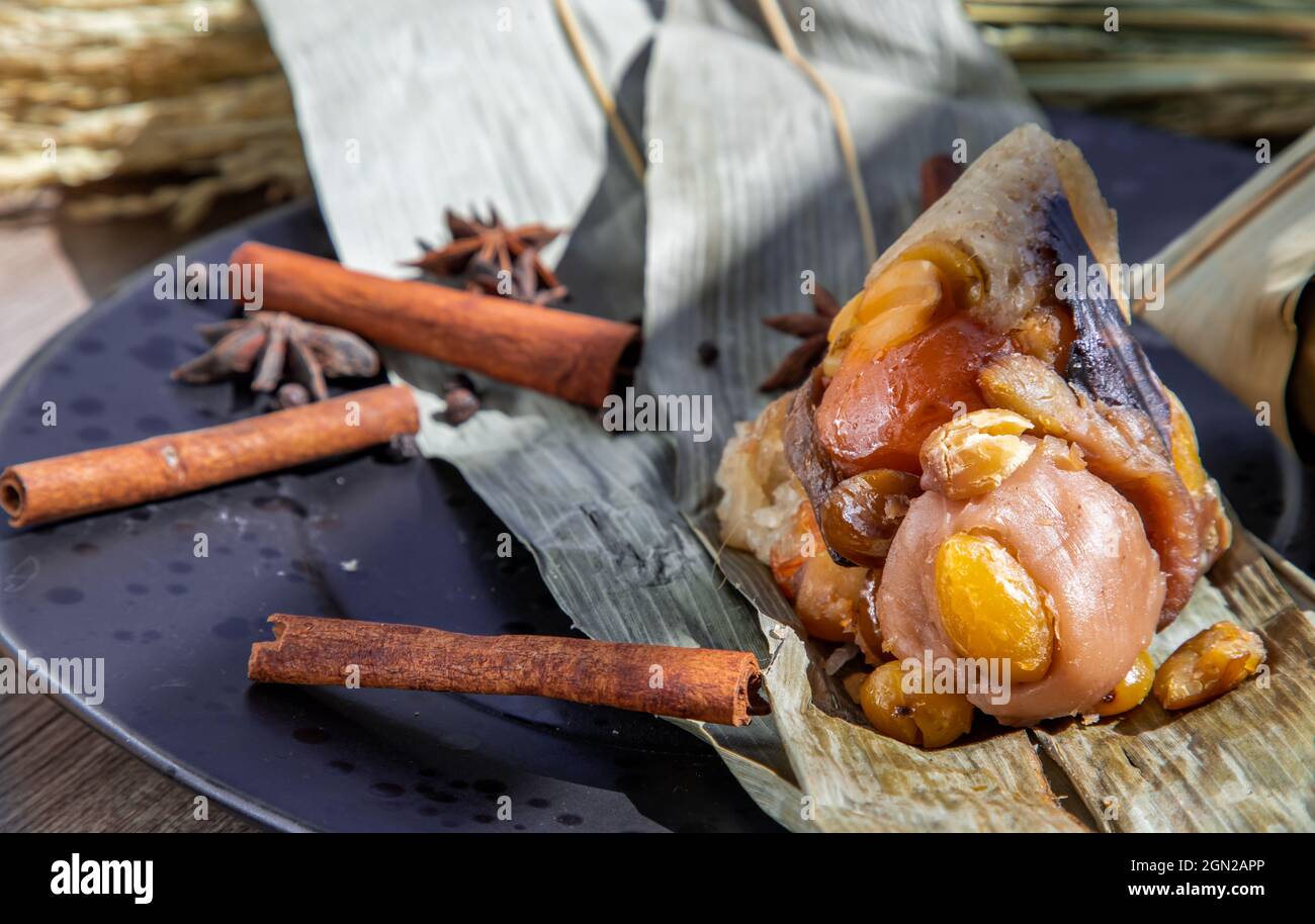 Chinese rice dumpling (Zongzi) shaped pyramidal wrapped by leaves ...