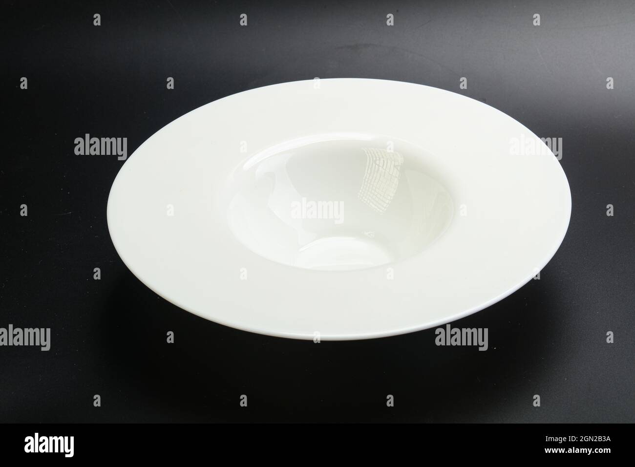 Empty white dish for pasta over black background Stock Photo - Alamy