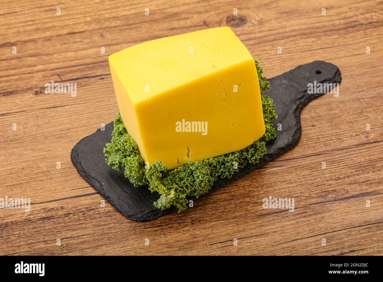 Yellow tilsiter cheese dairy product brick Stock Photo - Alamy