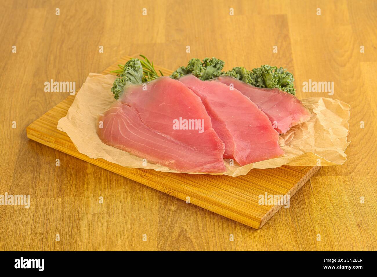 Raw salted tuna slice over board snack Stock Photo - Alamy