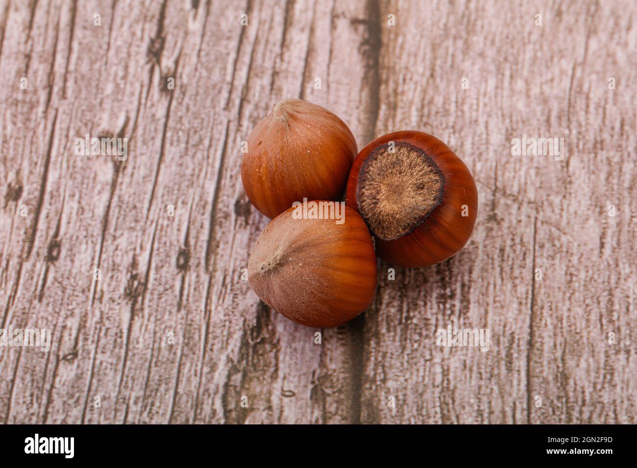 Hazelnut heap isolated over natural background Stock Photo - Alamy