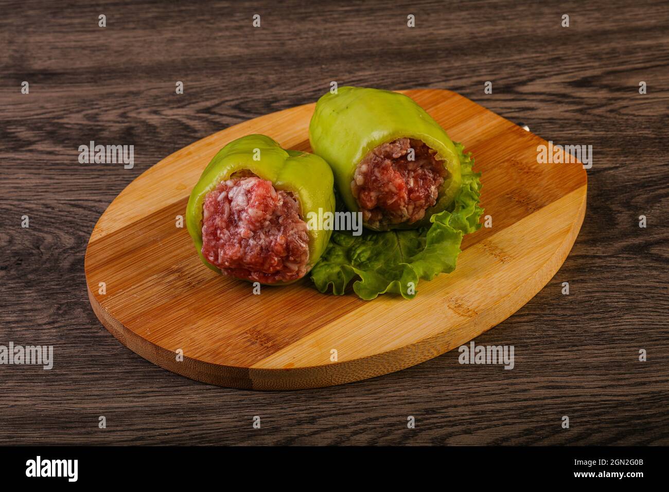 Raw stuffed green bell pepper with meat Stock Photo - Alamy