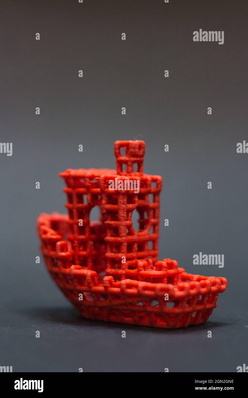 Vertical shot of a red toy boat isolated on gray background Stock Photo ...
