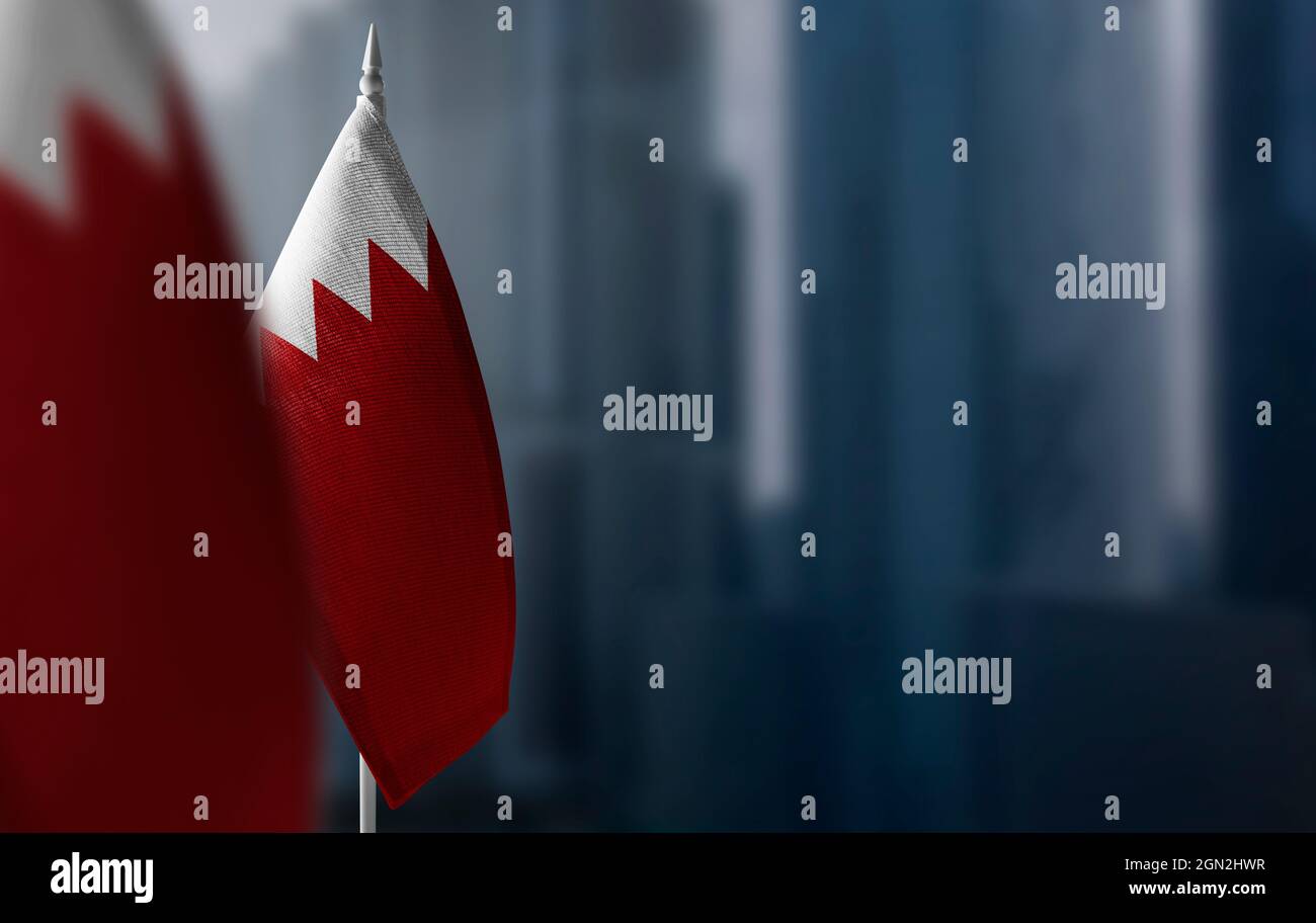 Small flags of Bahrain on a blurry background of the city Stock Photo ...