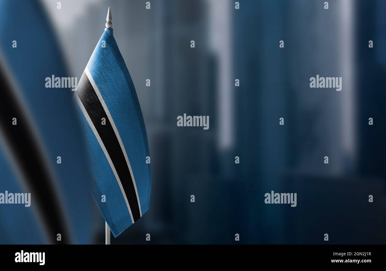 Small flags of Botswana on a blurry background of the city Stock Photo ...