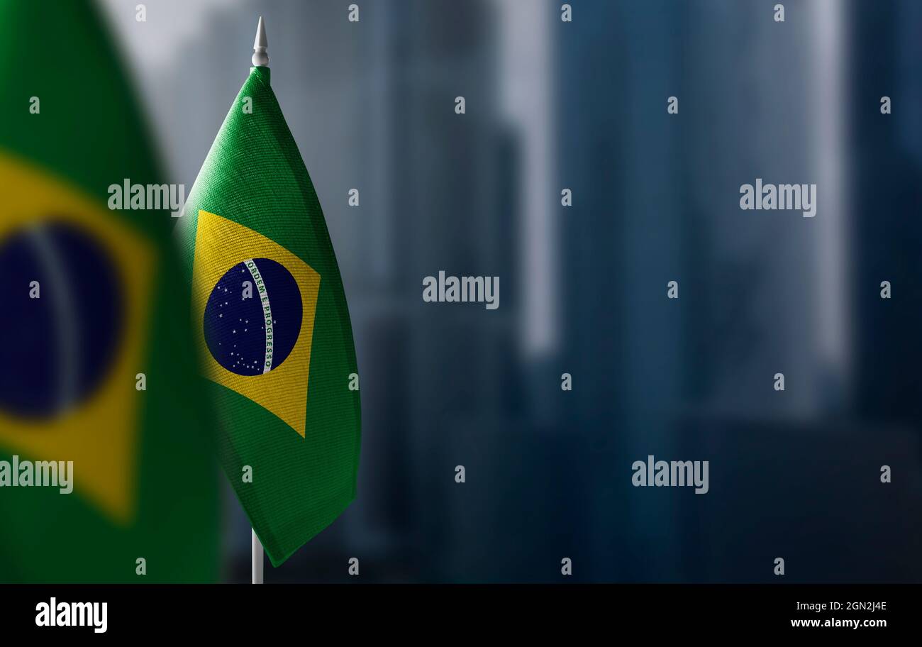 Small flags of Brazil on a blurry background of the city Stock Photo ...
